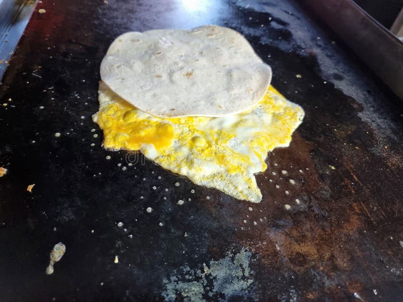 Plain Tortilla Wrap (Roti). Kebab are Being Cooked with Eggs on a Black ...