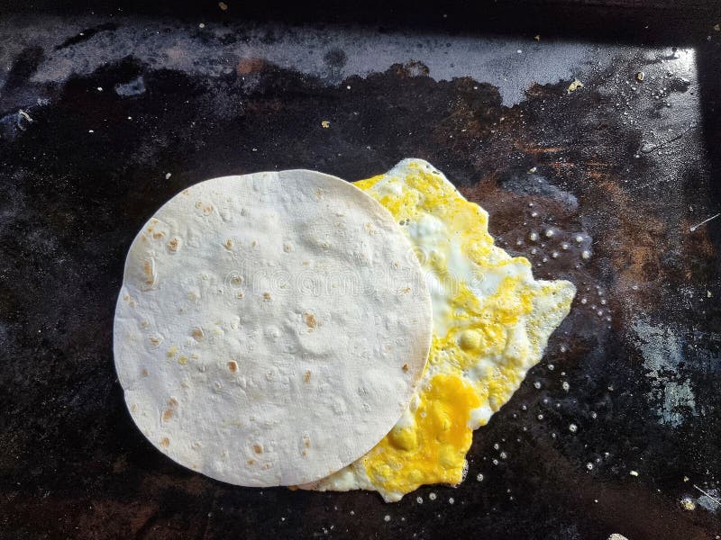 Plain Tortilla Wrap (Roti). Kebab are Being Cooked with Eggs on a Black ...