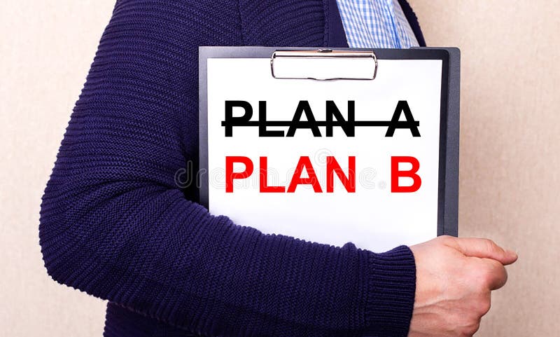 PLAN B is Written on a White Sheet Held by a Man Standing Sideways ...
