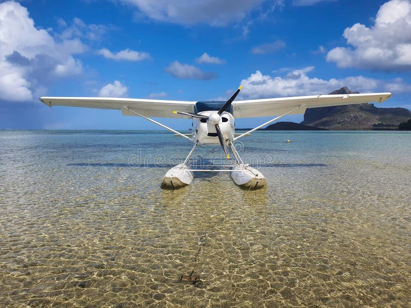 A Small Plane Parked in the Water Next To the Beach Stock Photo - Image ...