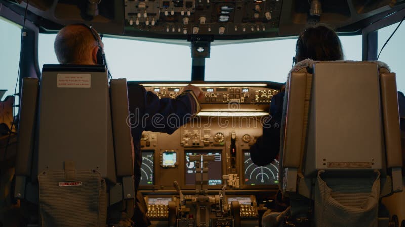 Plane Captain and Woman Copilot Fixing Altitude on Dashboard Stock ...