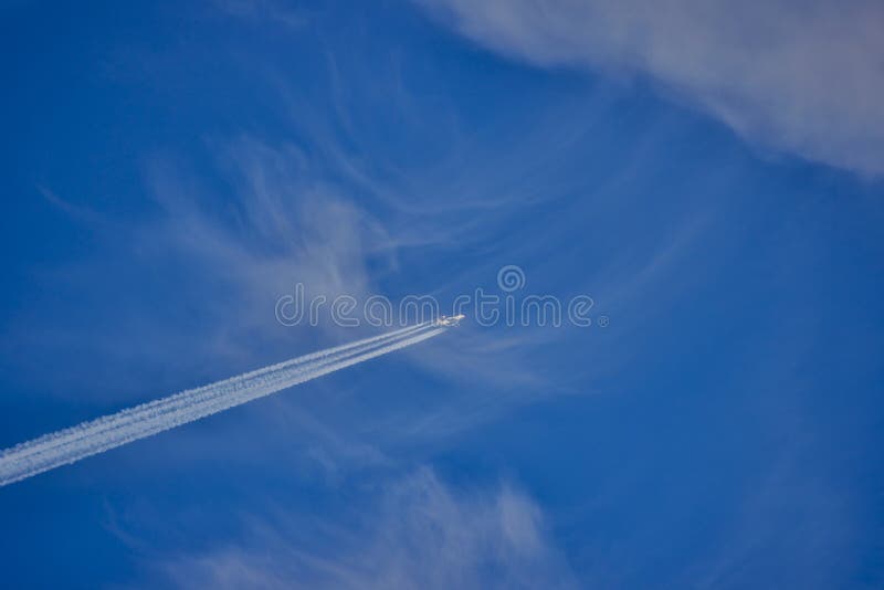 Plane Climbing with Tracks Behind it in the Blue Sky Stock Image ...