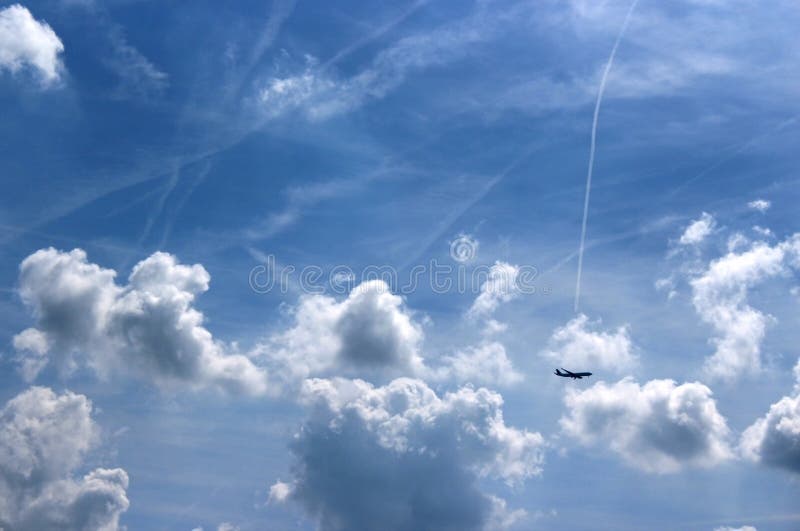 Plane among the Clouds in the Distance Stock Photo - Image of clouds ...