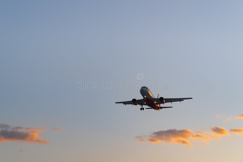 The Plane Comes in for Landing at Sunset Stock Photo - Image of ...