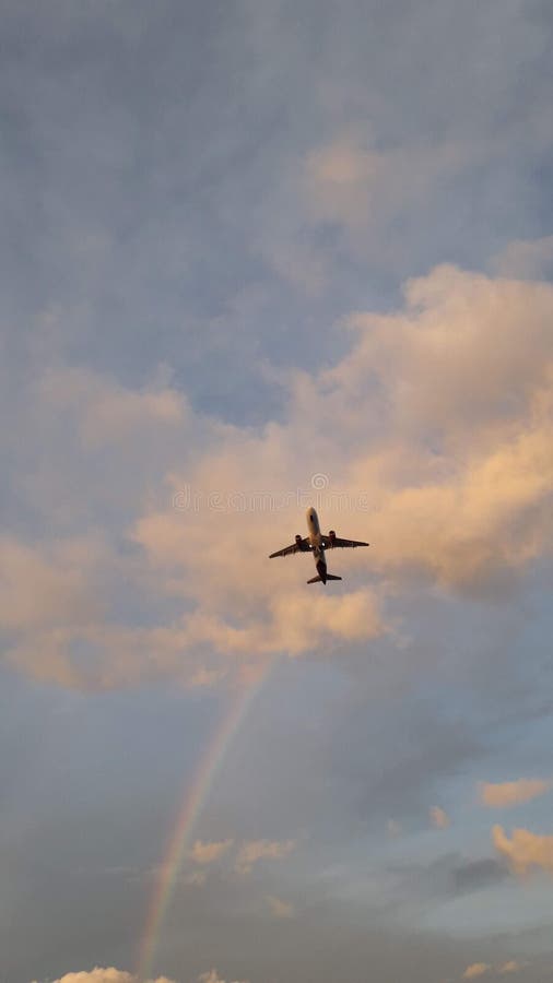 The Plane Crosses the Rainbow in the Sky Stock Photo - Image of ...