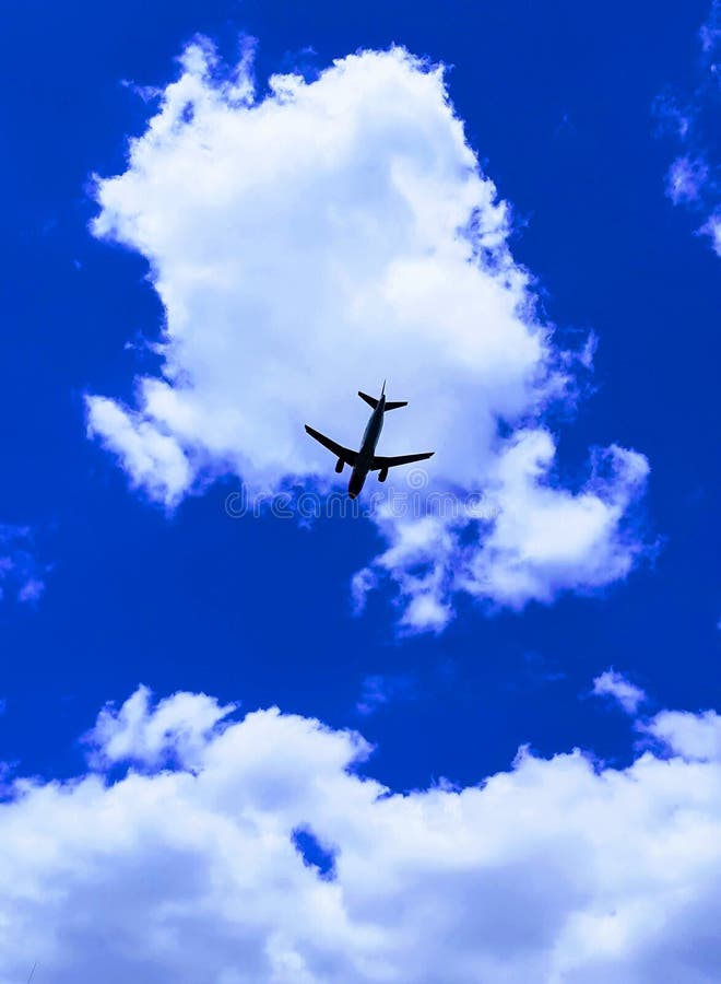 Plane in Deep Blue Sky with Clouds Stock Photo - Image of sunlight ...