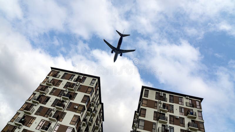 Plane Flies Low Over Houses Stock Photo - Image of aircraft, wall ...