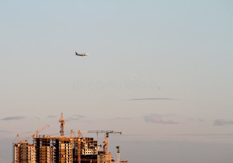 The Plane Flies Over a Construction Site with Cranes Stock Photo ...