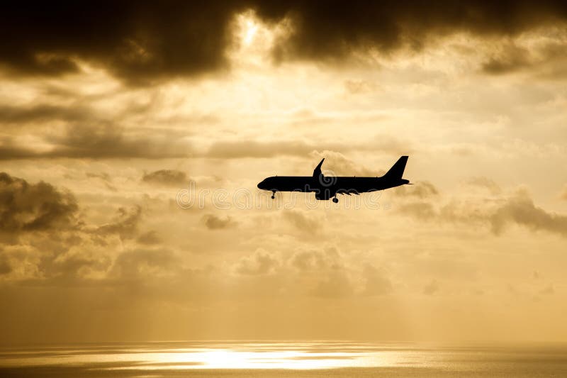 The Plane Flies Over the Sea in the Sun Rays. Stock Image - Image of ...