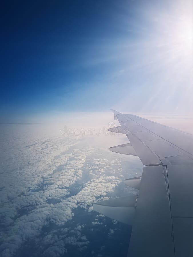 Plane Flight Above the Clouds. Blue Skyline and Airplane Wing Seen ...