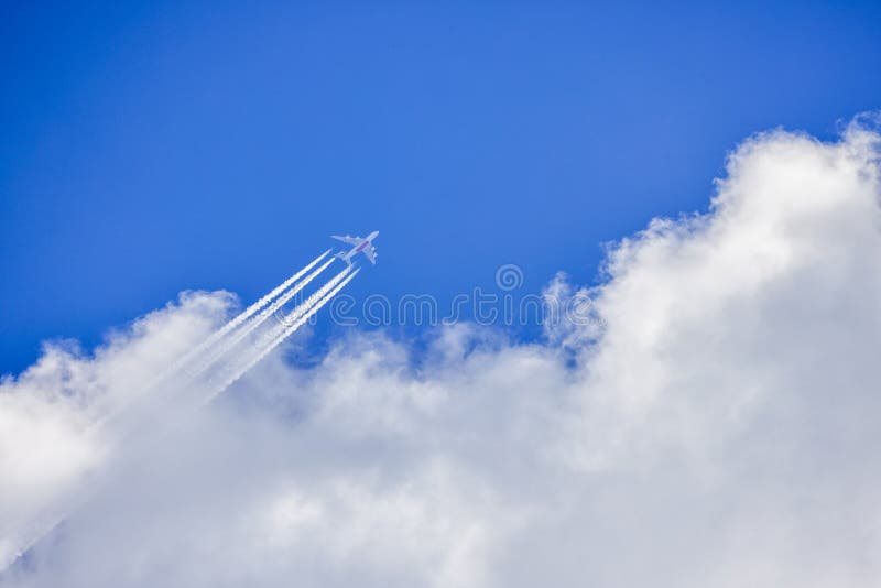 A Plane Flying through a Blue Cloudy Sky Stock Photo - Image of clouds ...
