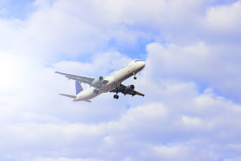 Plane Flying through Clouds in the Sky. Jet Aircraft. Editorial Stock ...