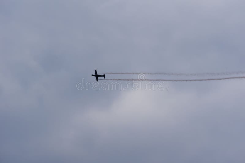 Plane Flying within Clouds with Smokes at Wings Stock Image - Image of ...