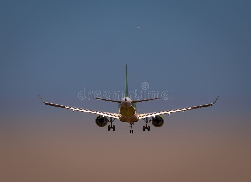 A Plane Flying into the Distance, into the Evening Sky, a View from the ...