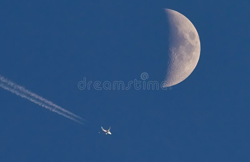 Plane Flying in Front of the Moon with a Jet Trail Behind it Stock ...