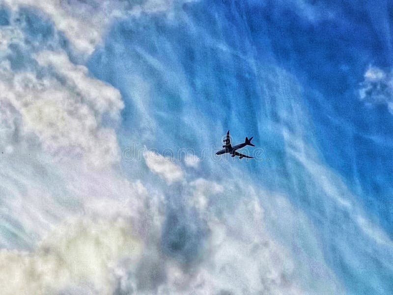 A Plane High Up in the Blue Cloudy Sky Flying Above Stock Image - Image ...