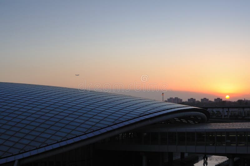 A Plane is Flying Over Airport Express Station Stock Photo - Image of ...