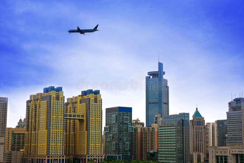 Plane flying over city stock photo. Image of district - 20506074