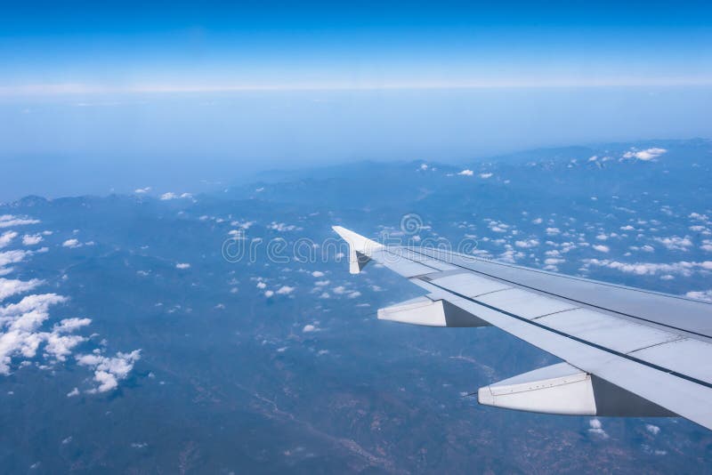 Plane flying over clouds stock photo. Image of clouds - 81409740