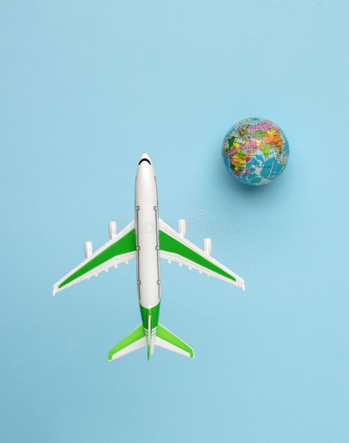 A Plane Flying Over the Globe on a Blue Background. Flat Lay Stock ...