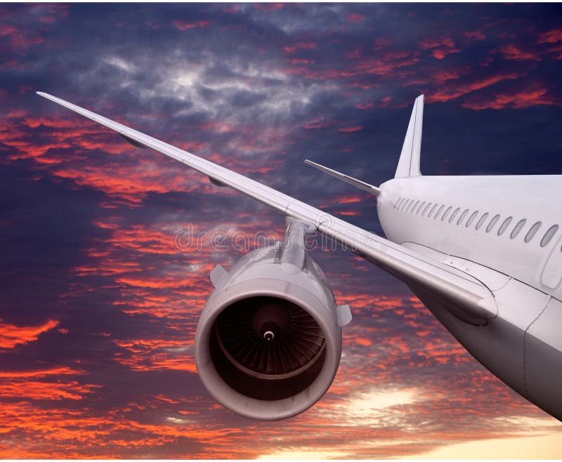 Plane is flying at sunset stock image. Image of modern - 76939893