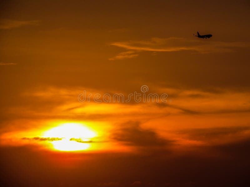 Plane flying at sunset stock image. Image of sunset, departure - 71734737