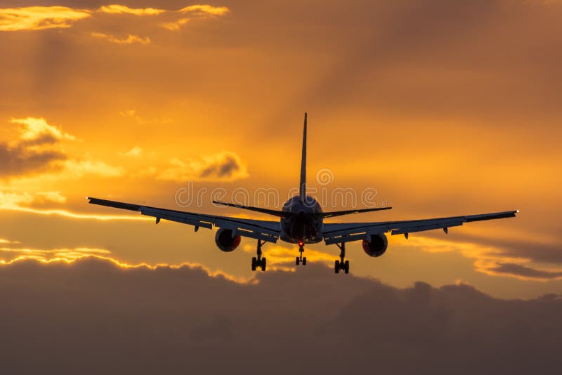 Plane Flying Towards the Runway during Sunrise. Stock Photo - Image of ...