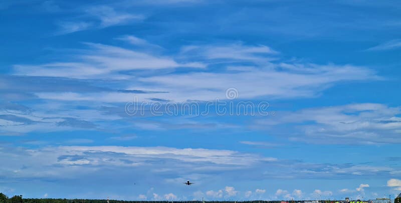 Plane Gains Altitude after Takeoff Against the Background of Blue ...