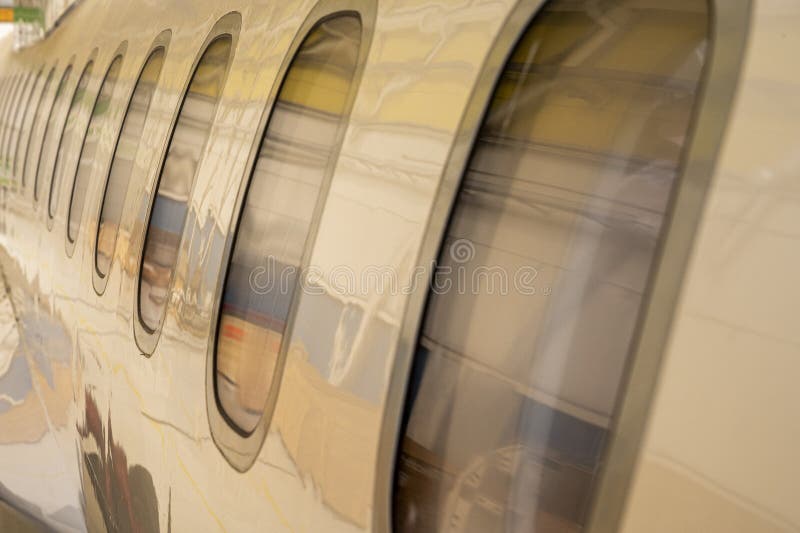 A Plane with Its Windows Open and a Reflection of the Sky in the ...