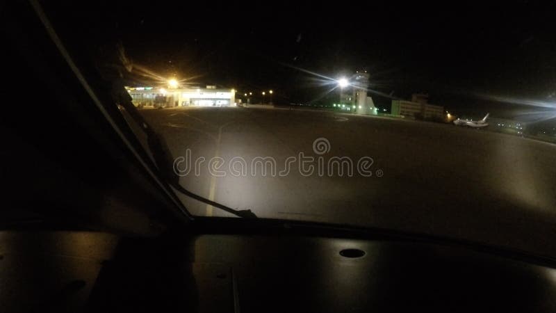 Plane Landing at the Airport during the Night. the View from the ...