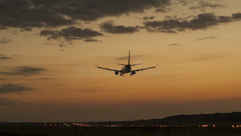 Plane landing in a sunset stock image. Image of commercial - 28132353