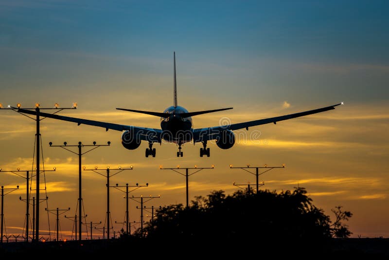 Plane landing in sunset stock image. Image of technology - 38800587