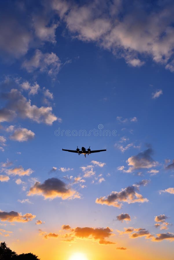 A plane landing at sunset stock image. Image of flight - 243043249