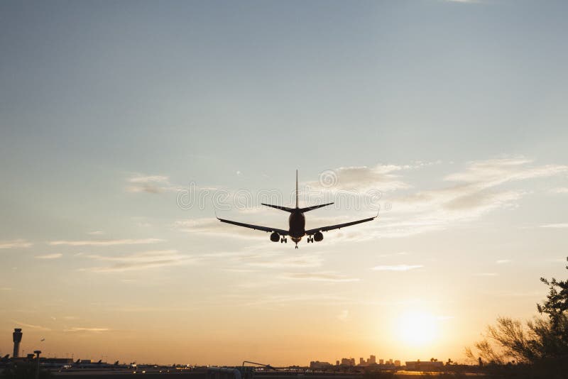 Plane Landing with Sunsetting Stock Photo - Image of transport ...