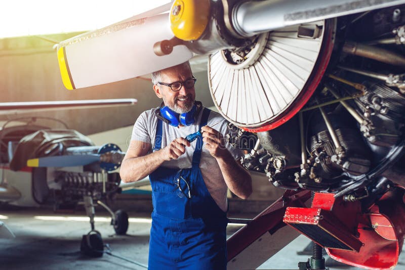 Plane Maintenance Engineer Repairing Engine Stock Image - Image of ...