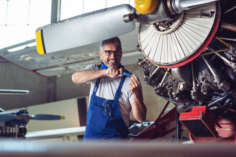 Plane Maintenance Engineer Repairing Engine Stock Image - Image of ...
