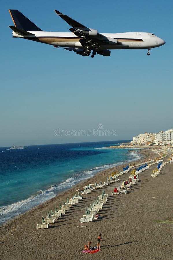 Plane over beach stock photo. Image of close, blue, airliner - 2419694