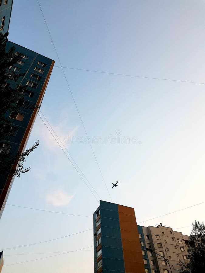 Plane over the city stock image. Image of lighting, architecture ...