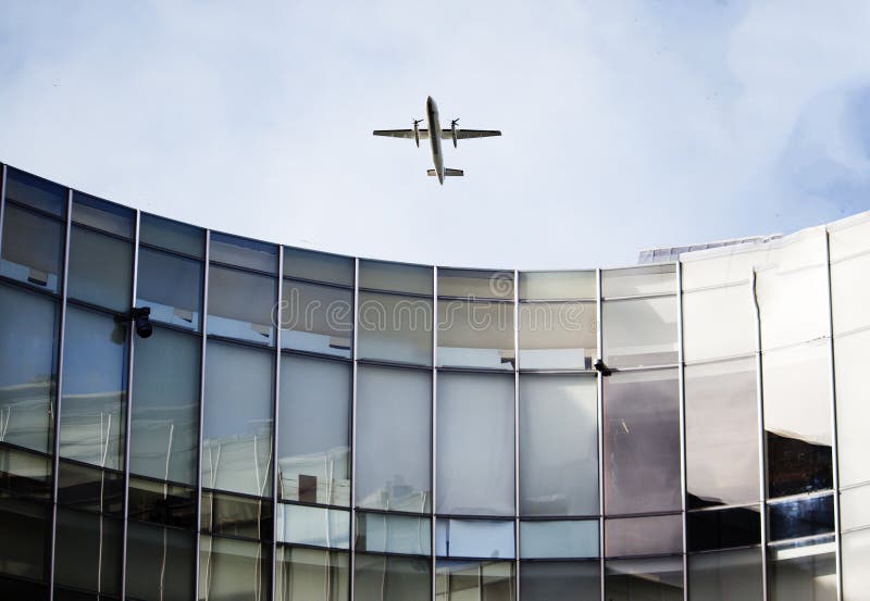 Plane over curved building stock photo. Image of airplane - 27395822
