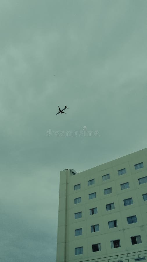 The Plane Passed Over the Building Stock Photo - Image of building ...