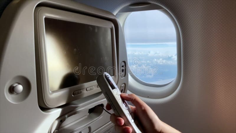 Plane Passenger Using Remote Control of Seat Monitor during the Flight ...