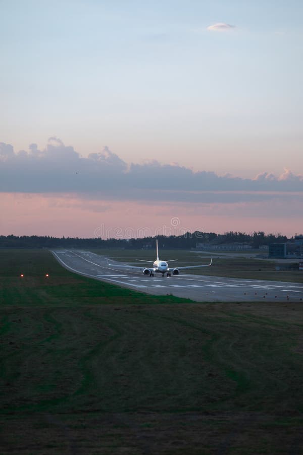 Plane on runway on sunset stock photo. Image of airplane - 216446180