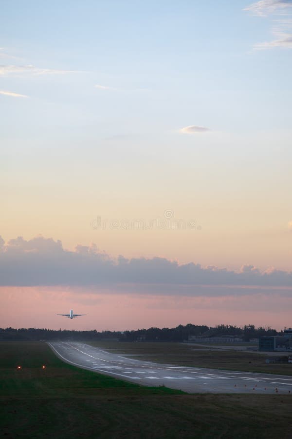 Plane on runway on sunset stock photo. Image of travel - 218396976