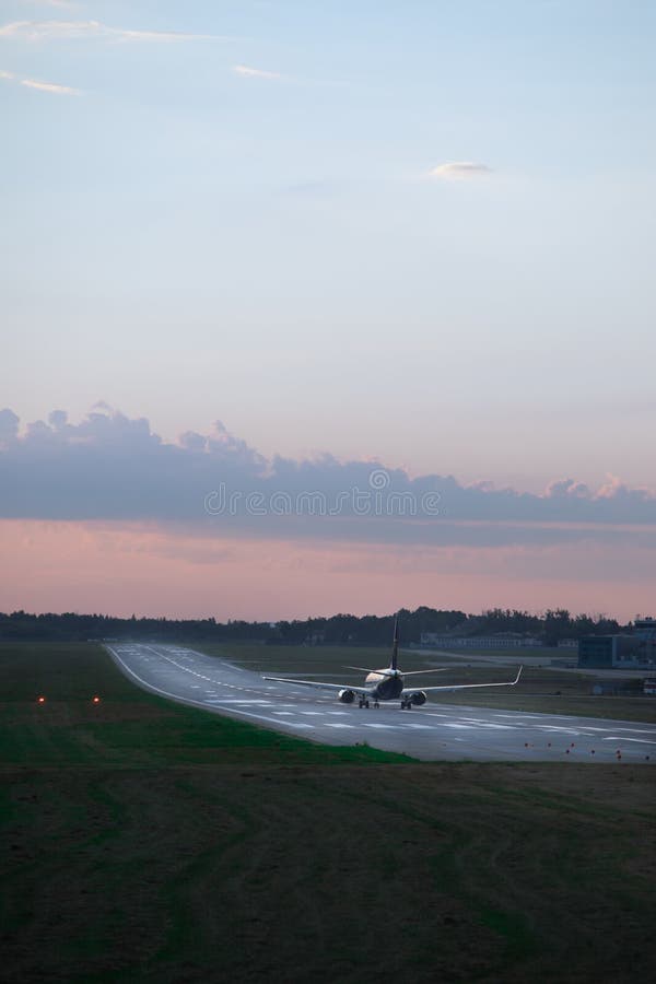 Plane on runway on sunset stock photo. Image of plane - 218397288