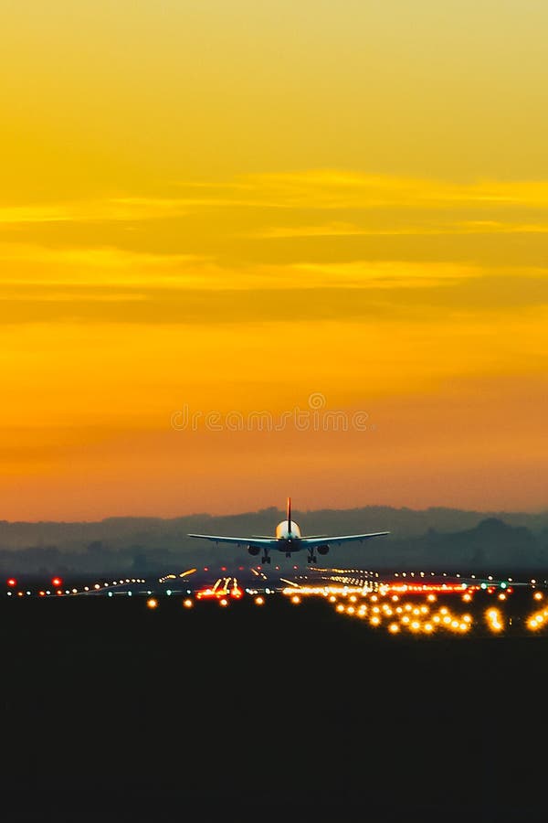 The Plane Takes Off from the Airport Runway during Sunset at Dusk Stock ...