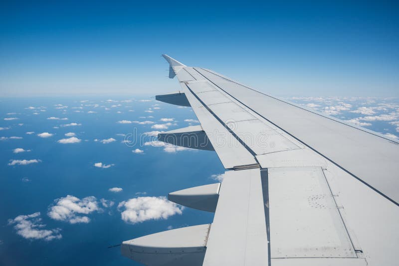 Plane wing over clouds stock photo. Image of travel - 169992024