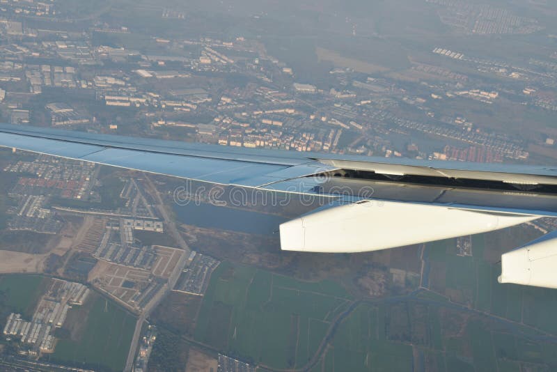 Plane Wing through Window Frame and City View on Ground Stock Image ...