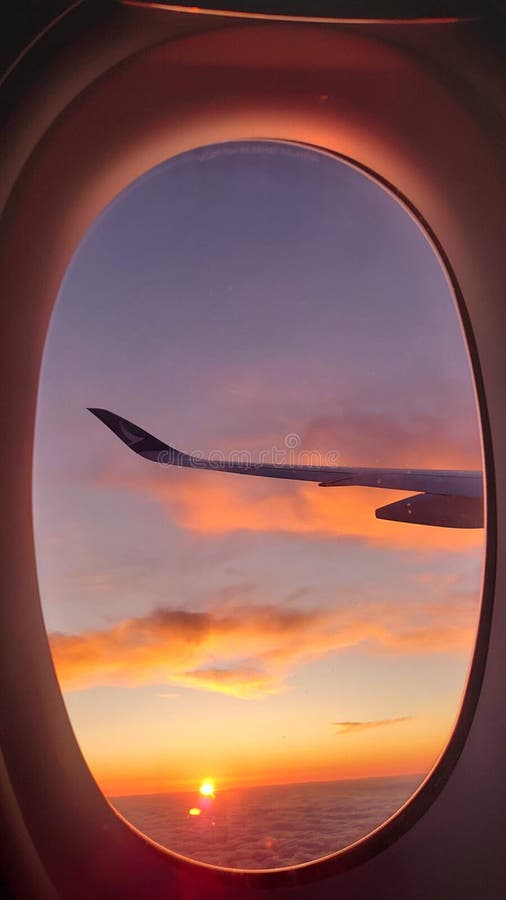 Plane Wing through the Window in a Sunset Editorial Stock Photo - Image ...