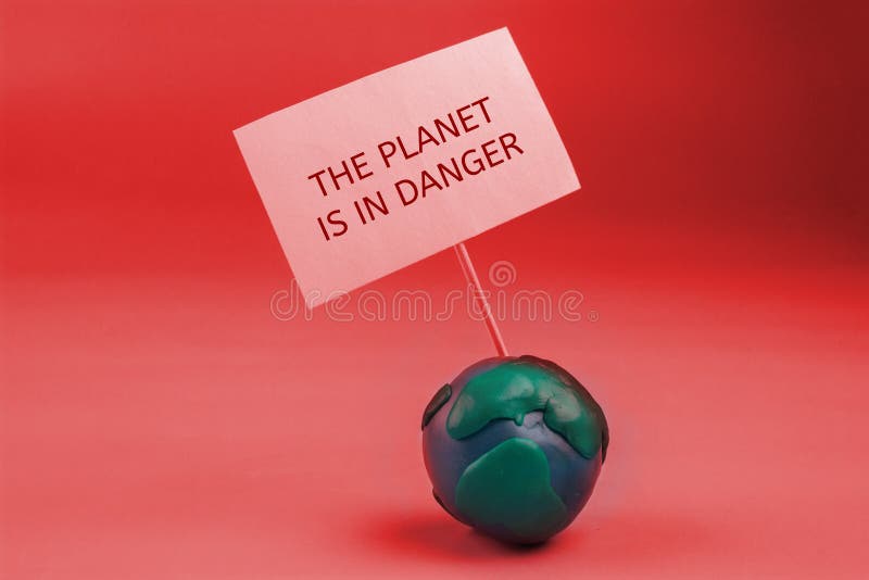 The Planet Earth in Danger Concept. Earth Holding a Banner Stock Photo ...