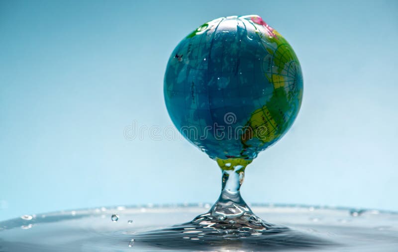Planet Earth in the Form of a Globe in Clear Water with Splashes ...